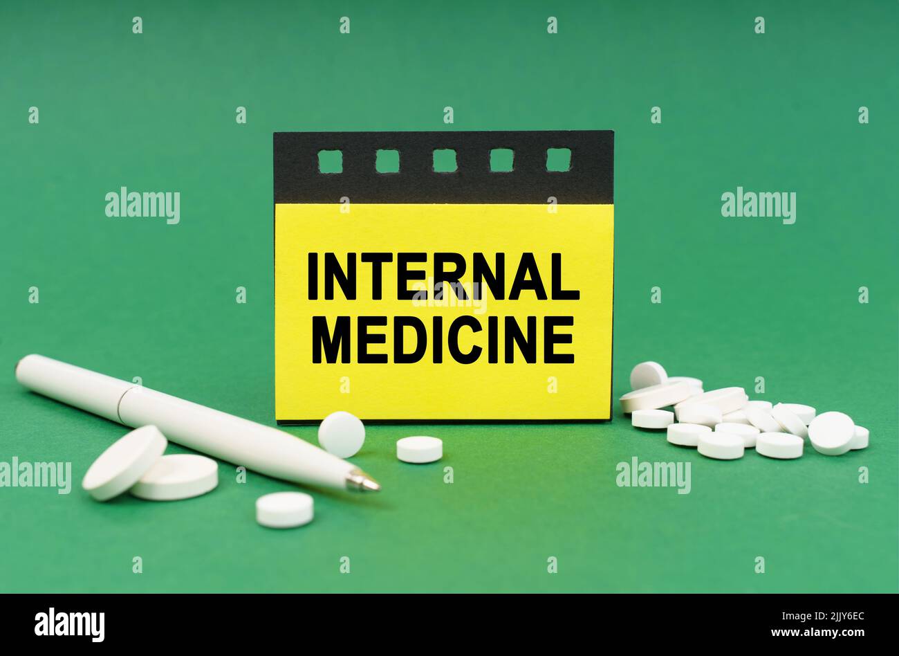 Medical concept. On the green surface are tablets, a pen and stickers ...