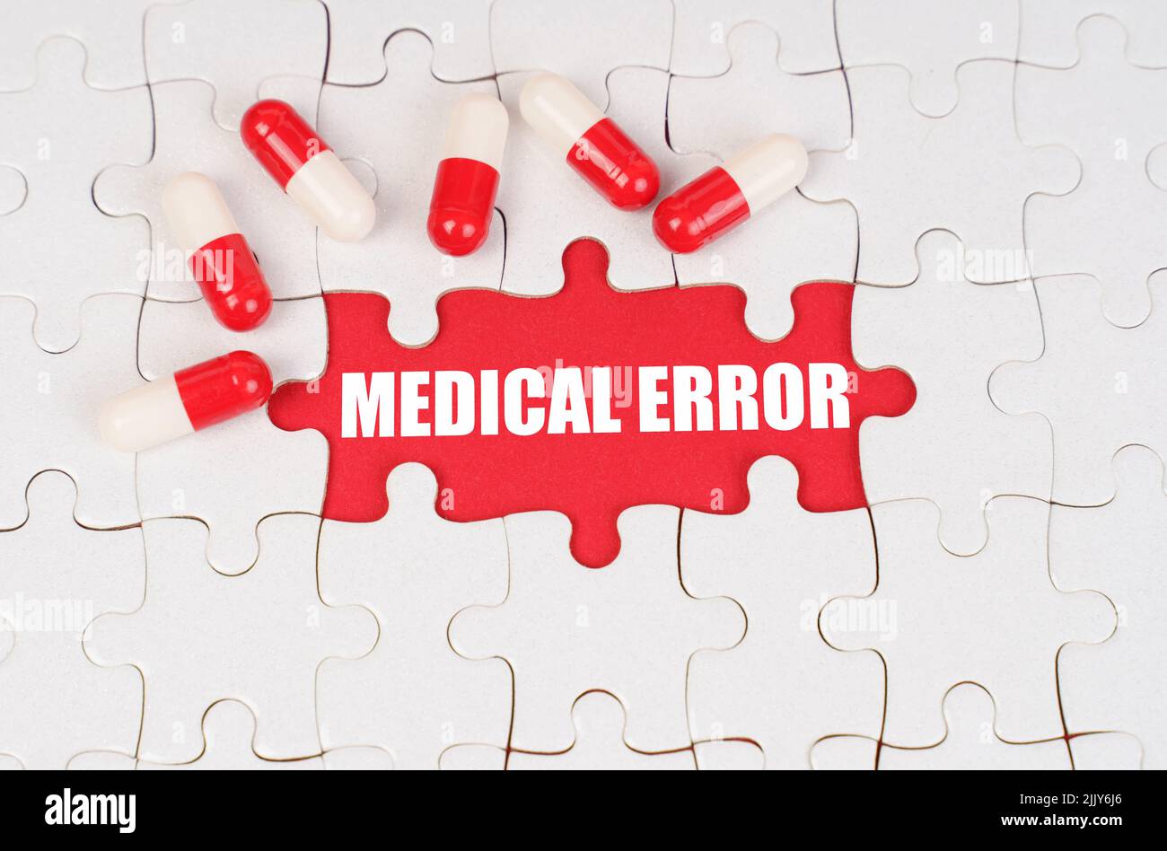 Medical concept. There are pills on the white puzzles, in the middle ...