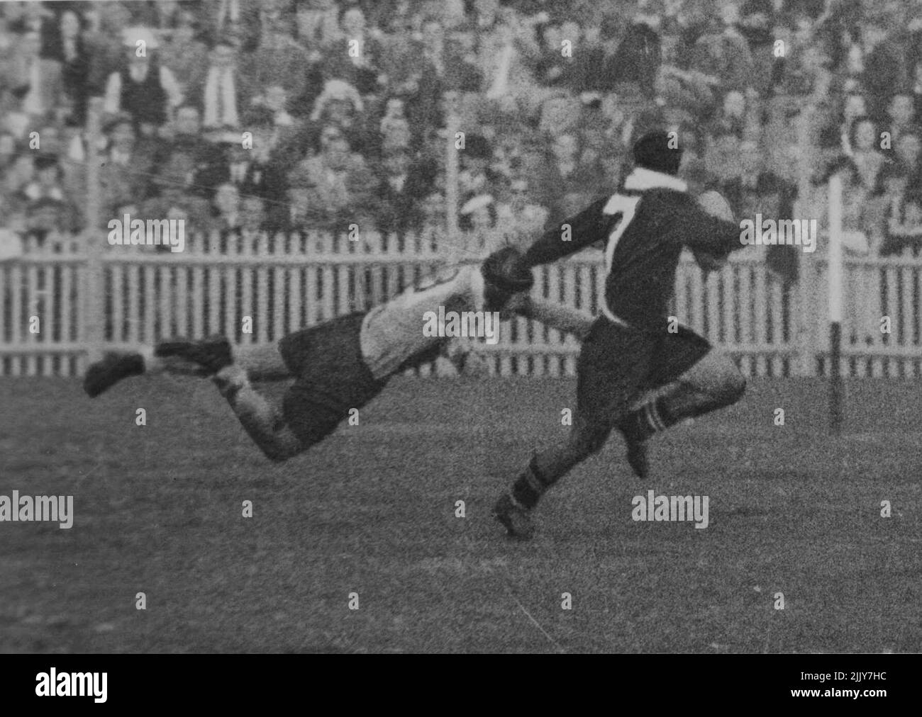 Powerful leg drive directs tackler's body to hit back of opponent's ...