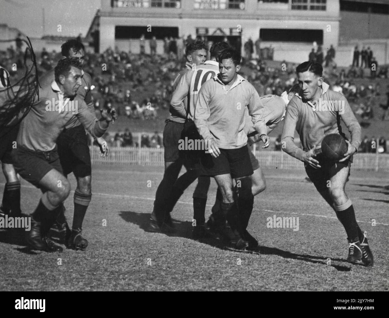 Roy Cawley the Rest's half back (right) dashes fast Queensland forward ...