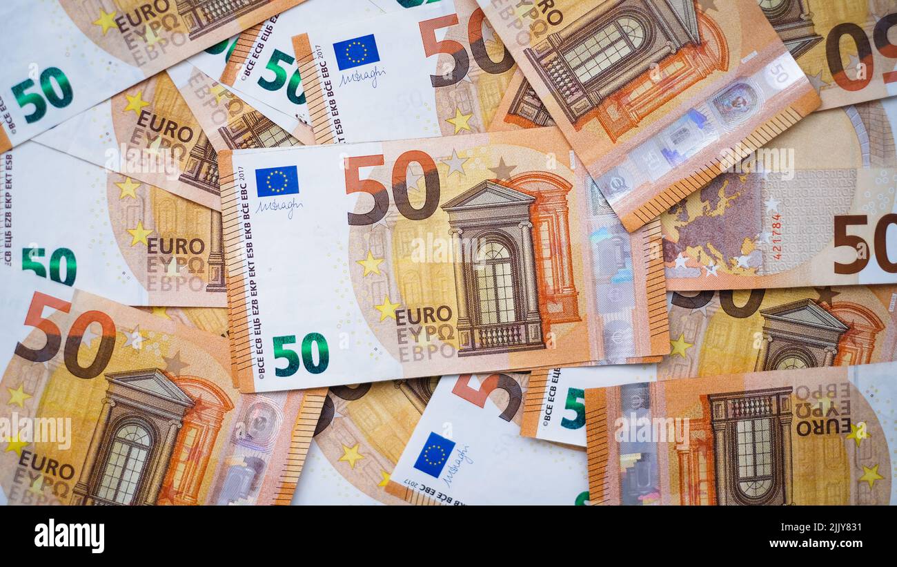 The background consists of many euro banknotes of different ...