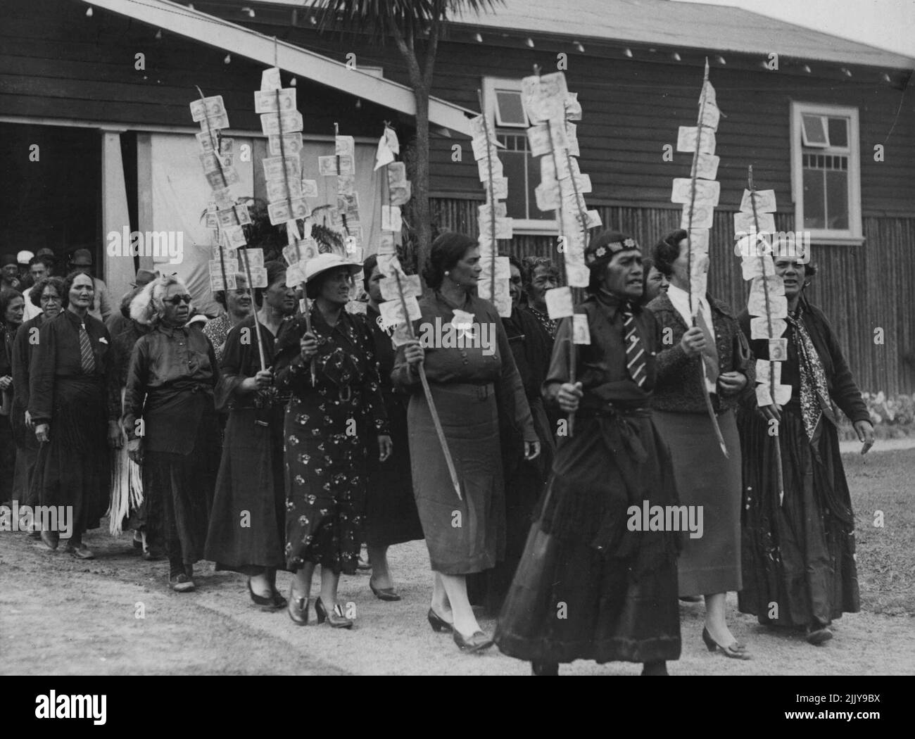 Maori women bringing bank notes on poles as contributions toward the ...