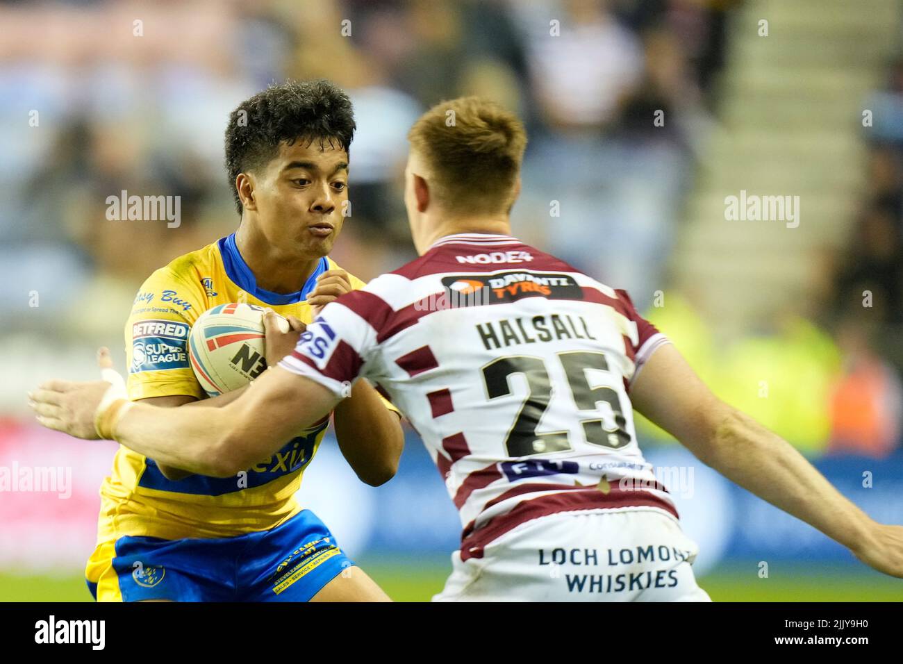 Phoenix Laulu-TogagaÕe #29 of Hull KR runs at Sam Halsall #25 of Wigan ...