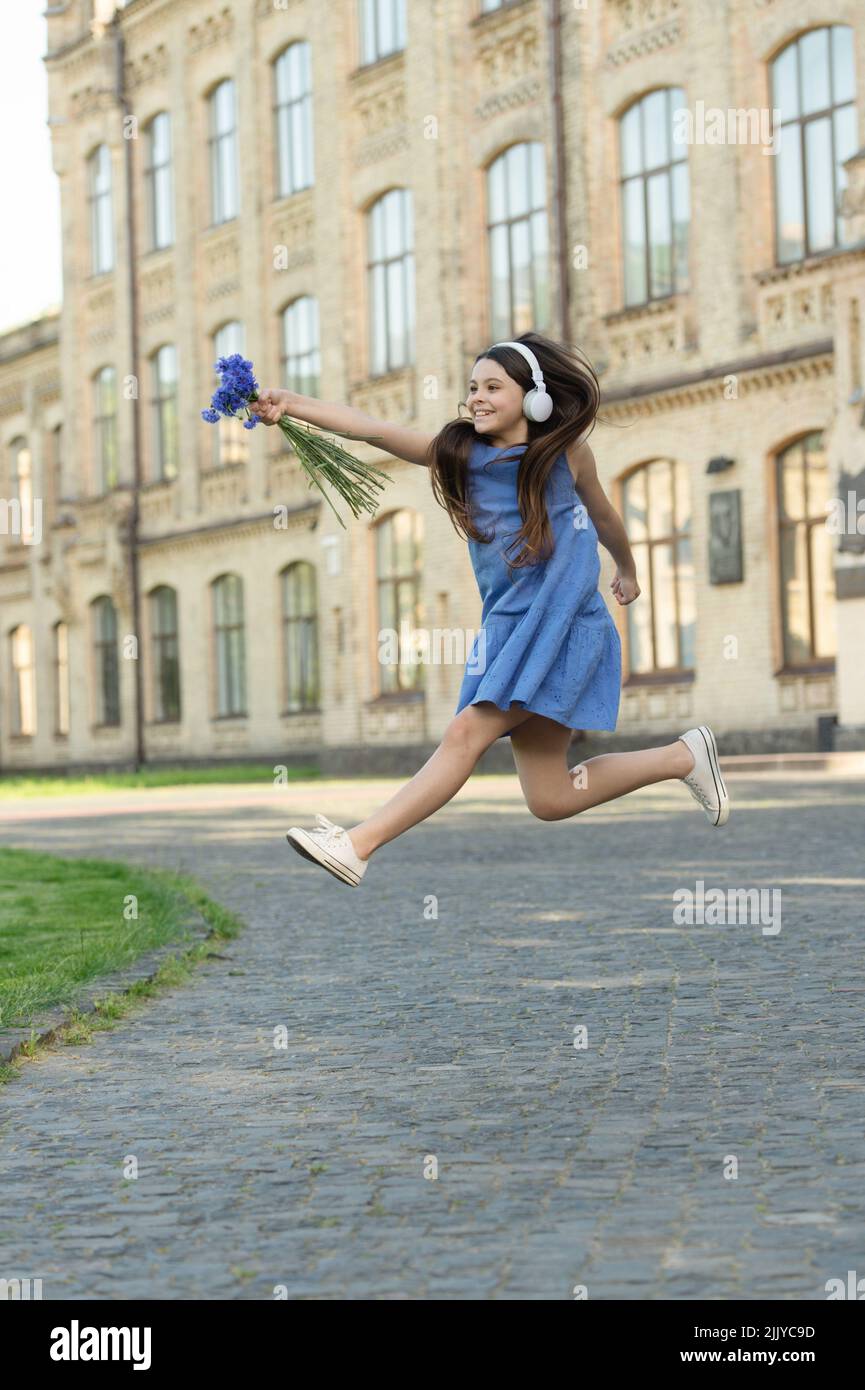 happy teen girl in headphones. girl run outdoor. carefree girl running ...