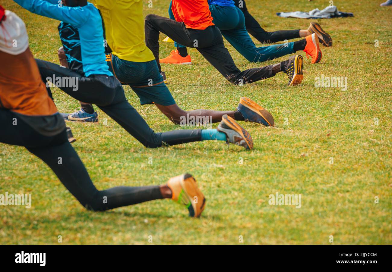 Stretching and warm-up of African runners. Joggers and marathon runners ...