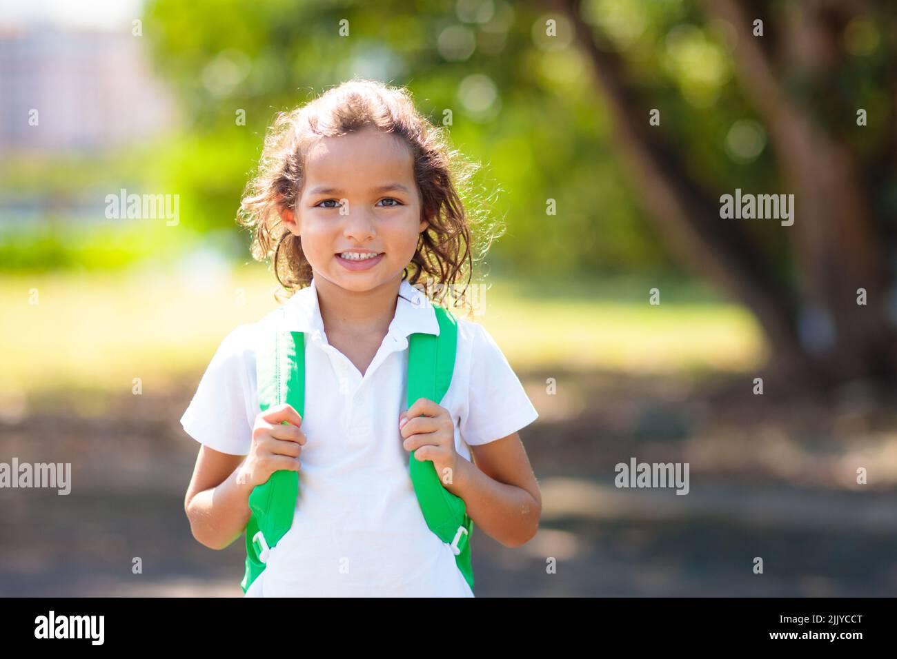 Kids go back to school. Interracial group of children of mixed age run ...