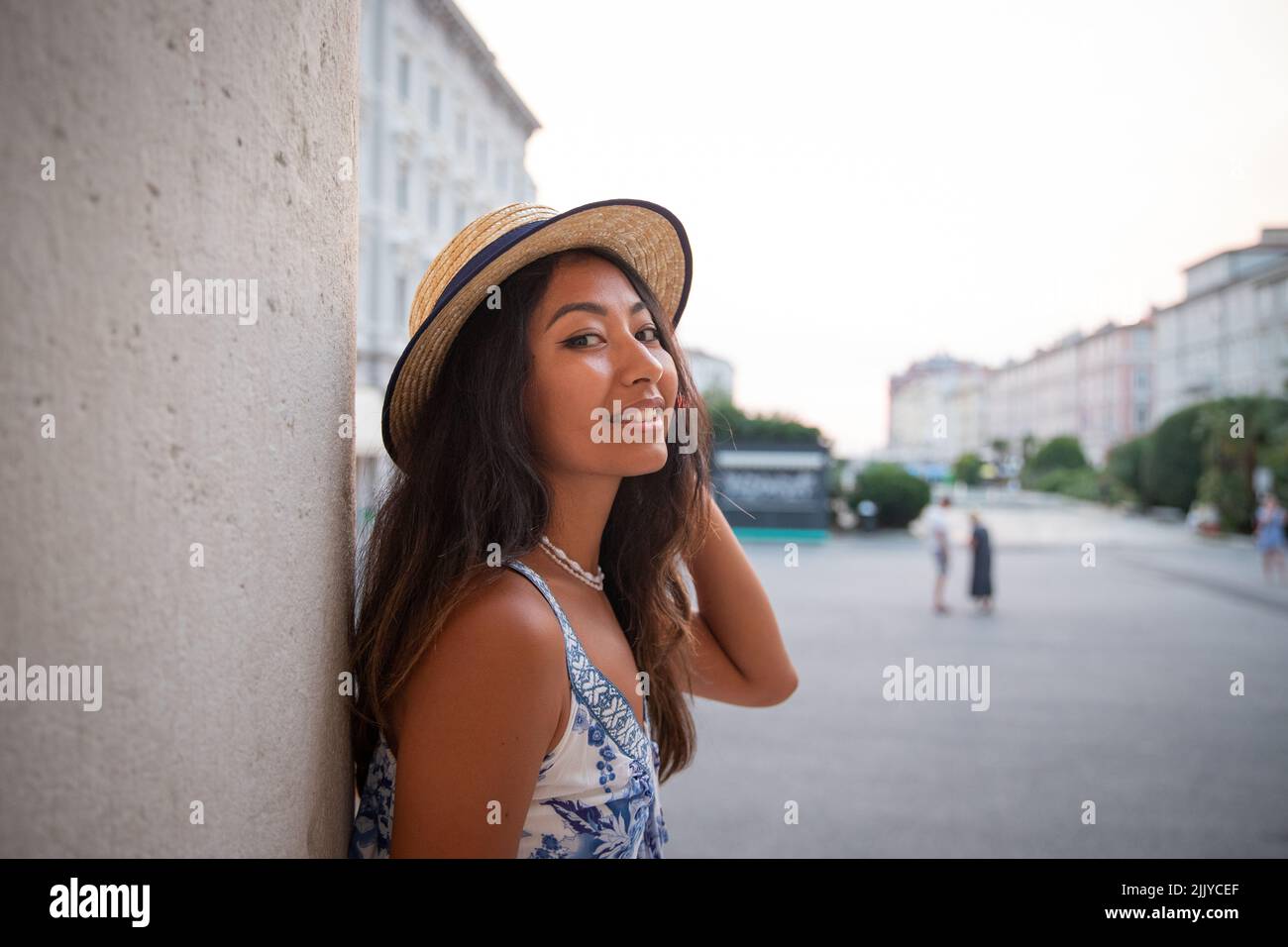 Portrait of a happy Asian tourist during her vacation in Italy, smiling ...