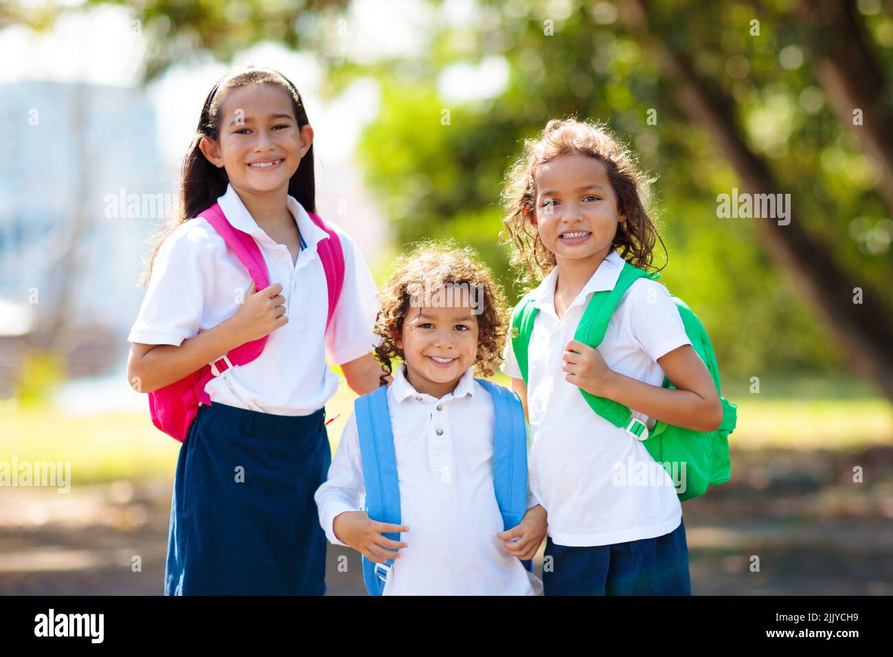Kids go back to school. Interracial group of children of mixed age run ...
