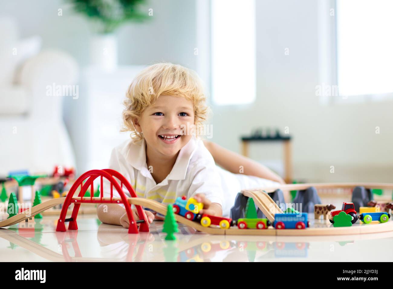 Kids play with wooden railway. Child with toy train. Educational toys ...
