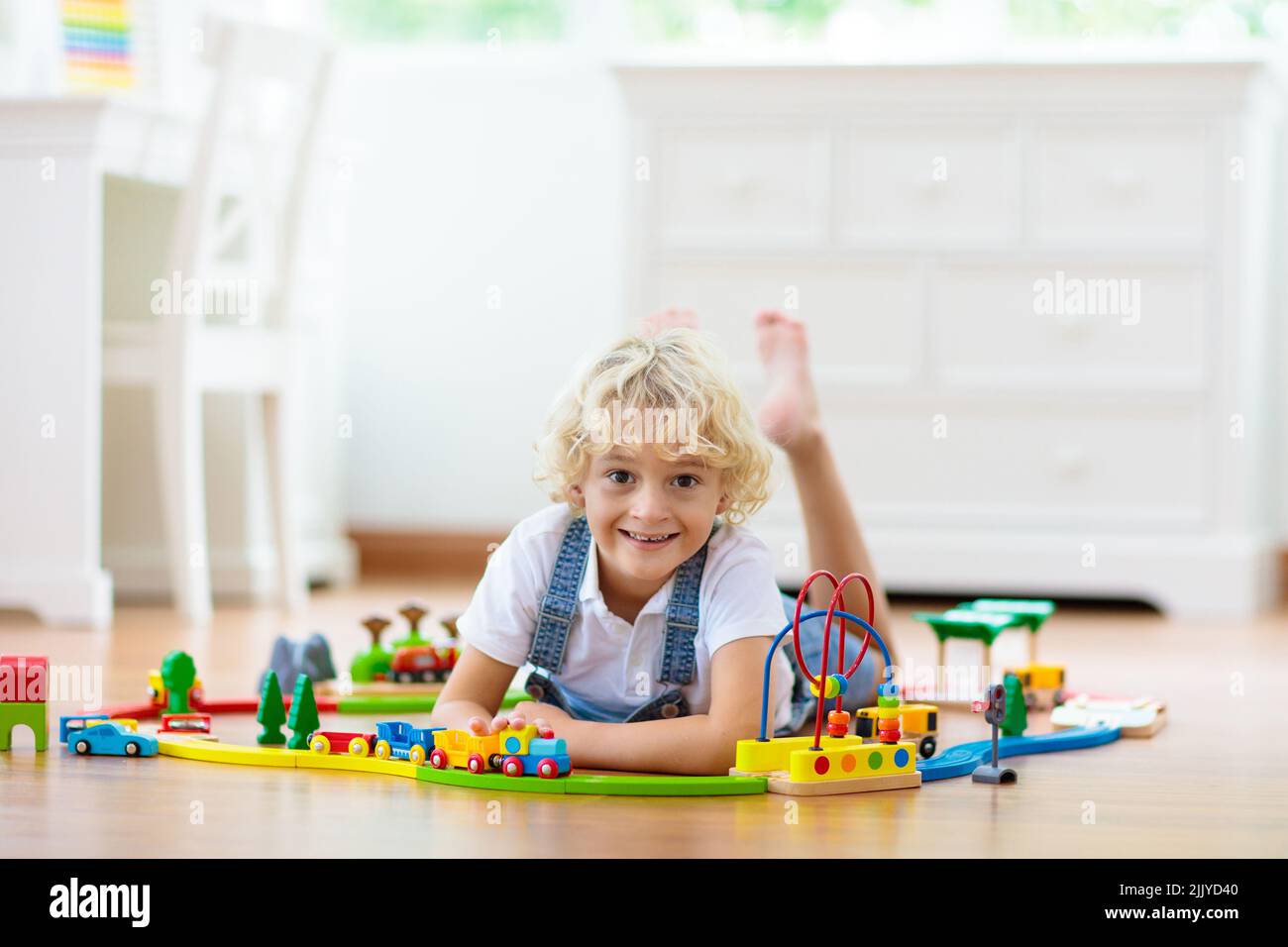 Kids play with wooden railway. Child with toy train. Educational toys ...