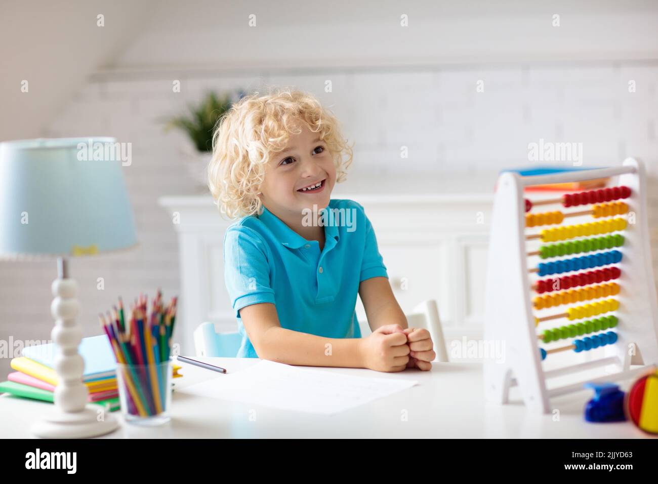 Child doing homework at home. Little boy with wooden colorful abacus ...