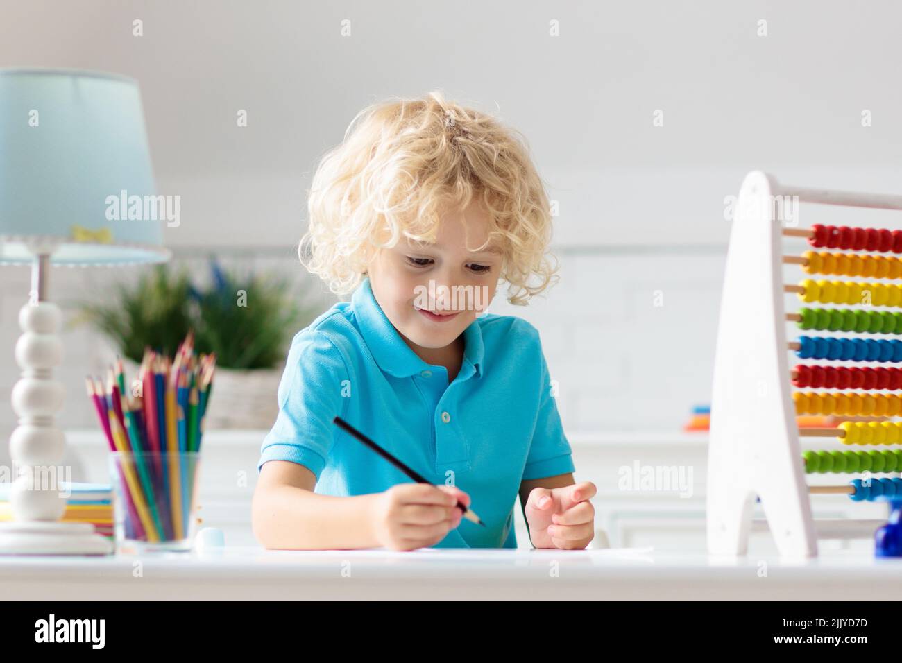 Child doing homework at home. Little boy with wooden colorful abacus ...