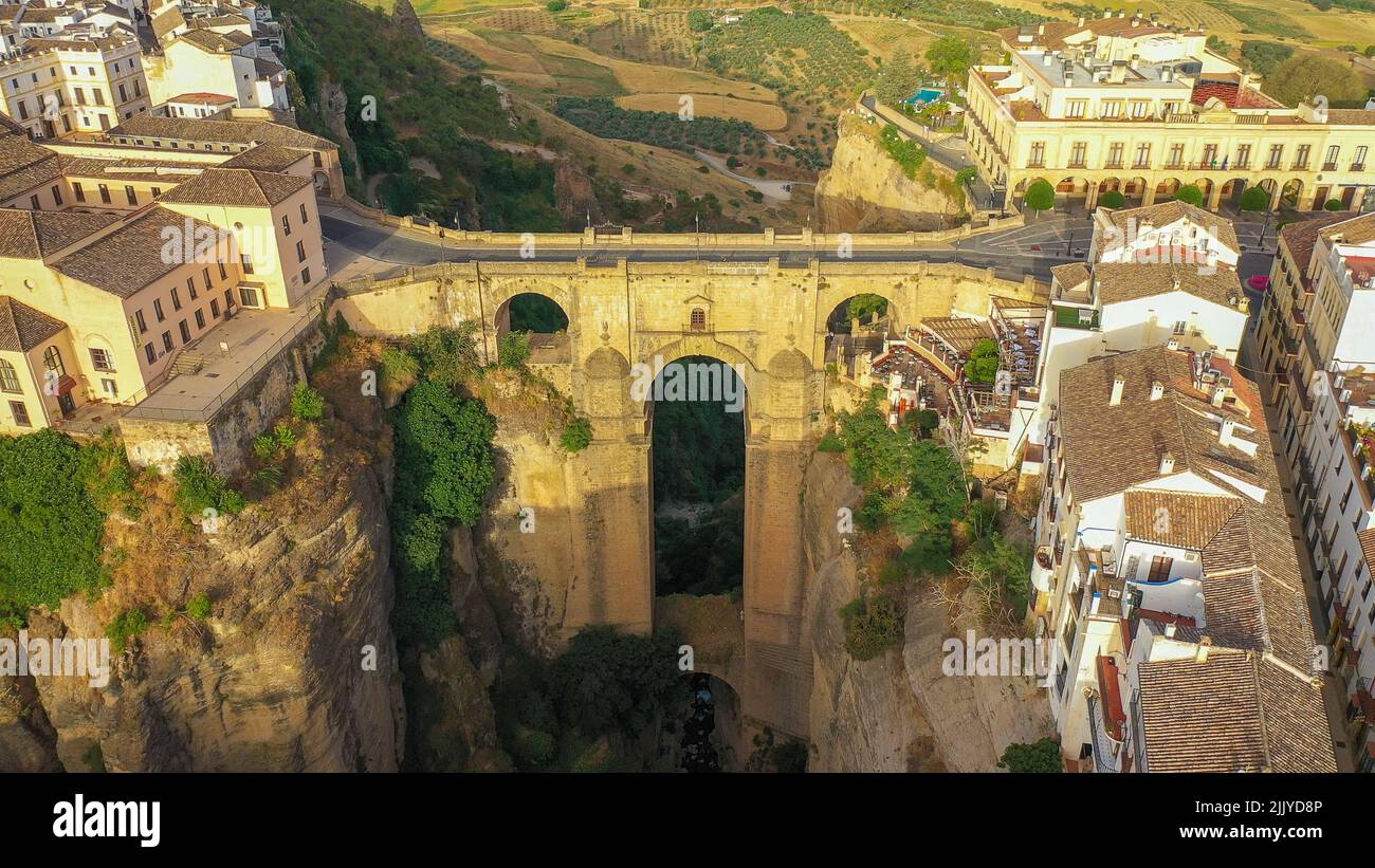 Aerial view of the Puente Nuevo Bridge in the hilltop village of Ronda, Spain at sunrise. Bridge ...