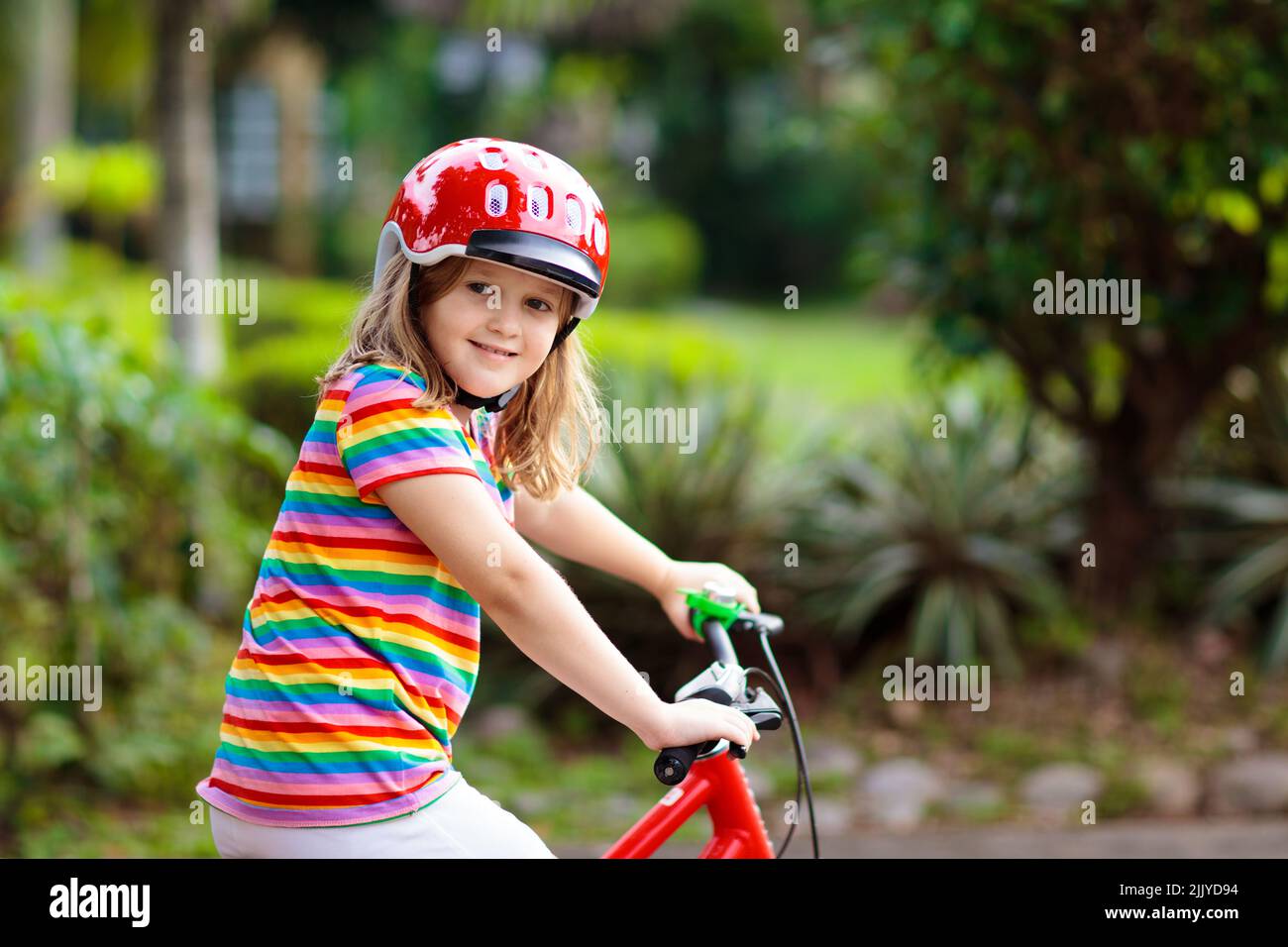 Kids on bike in park. Children going to school wearing safe bicycle ...