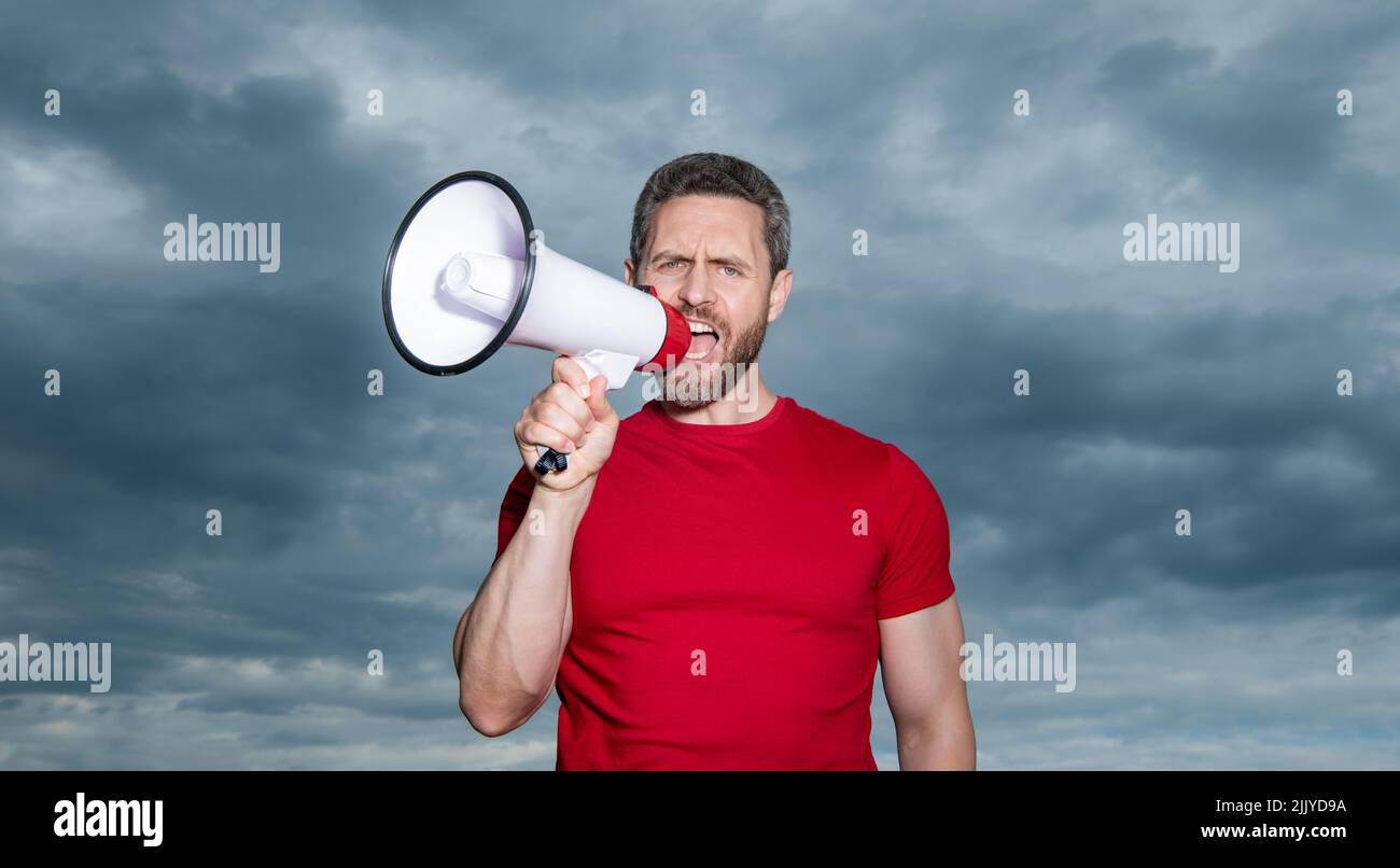 man in red shirt shout loud in loudspeaker on sky background Stock ...