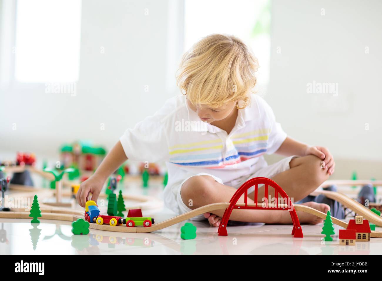 Kids play with wooden railway. Child with toy train. Educational toys ...