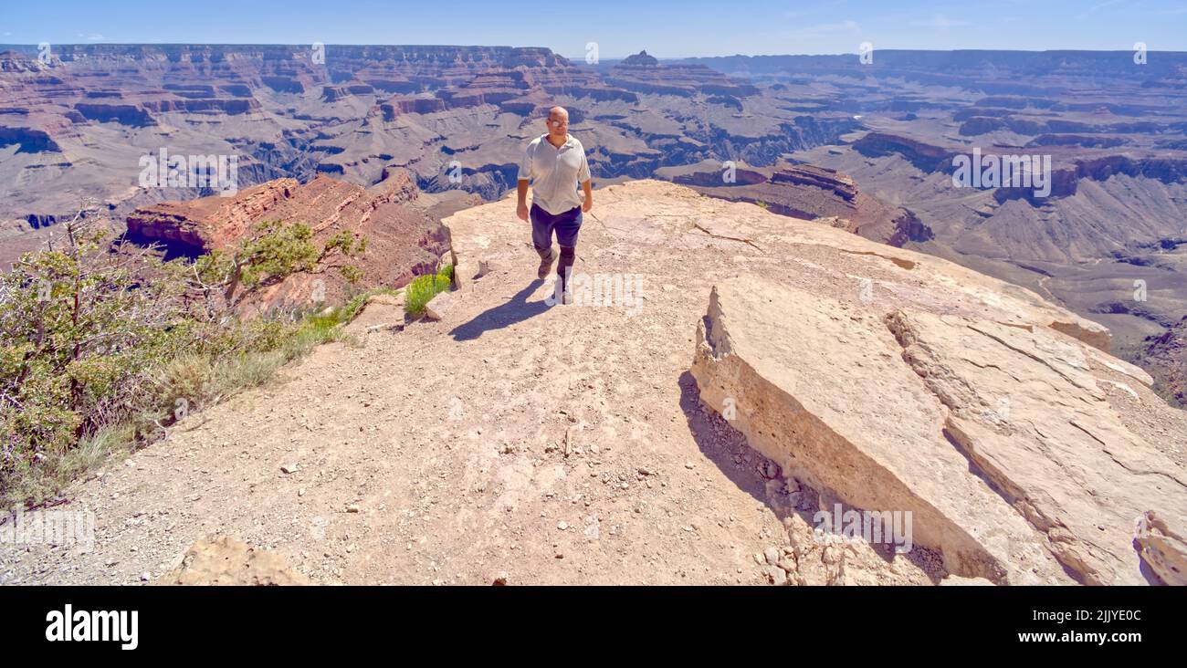 A man walking away from the edge of Shoshone Point at Grand Canyon Arizona Stock Photo - Alamy