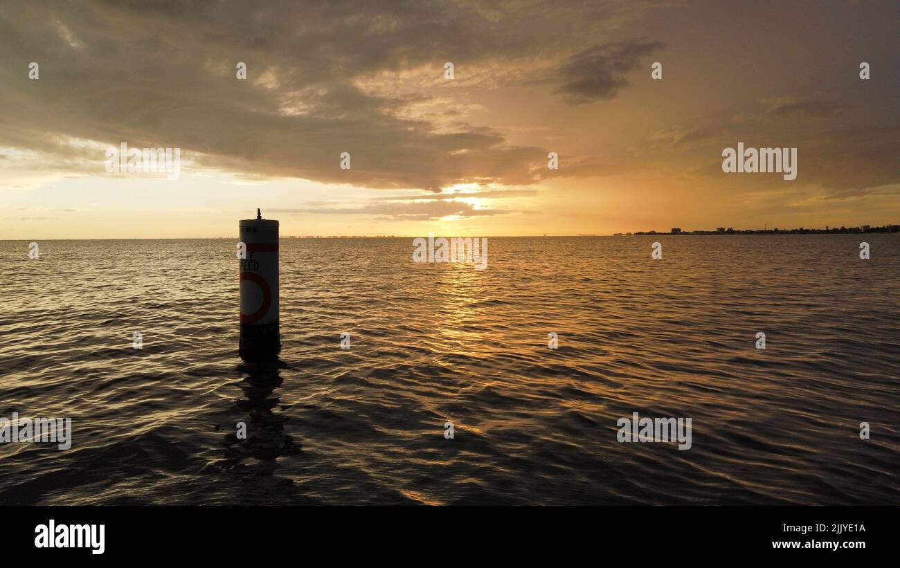 A single buoy floating in the ocean at sunset Stock Photo - Alamy