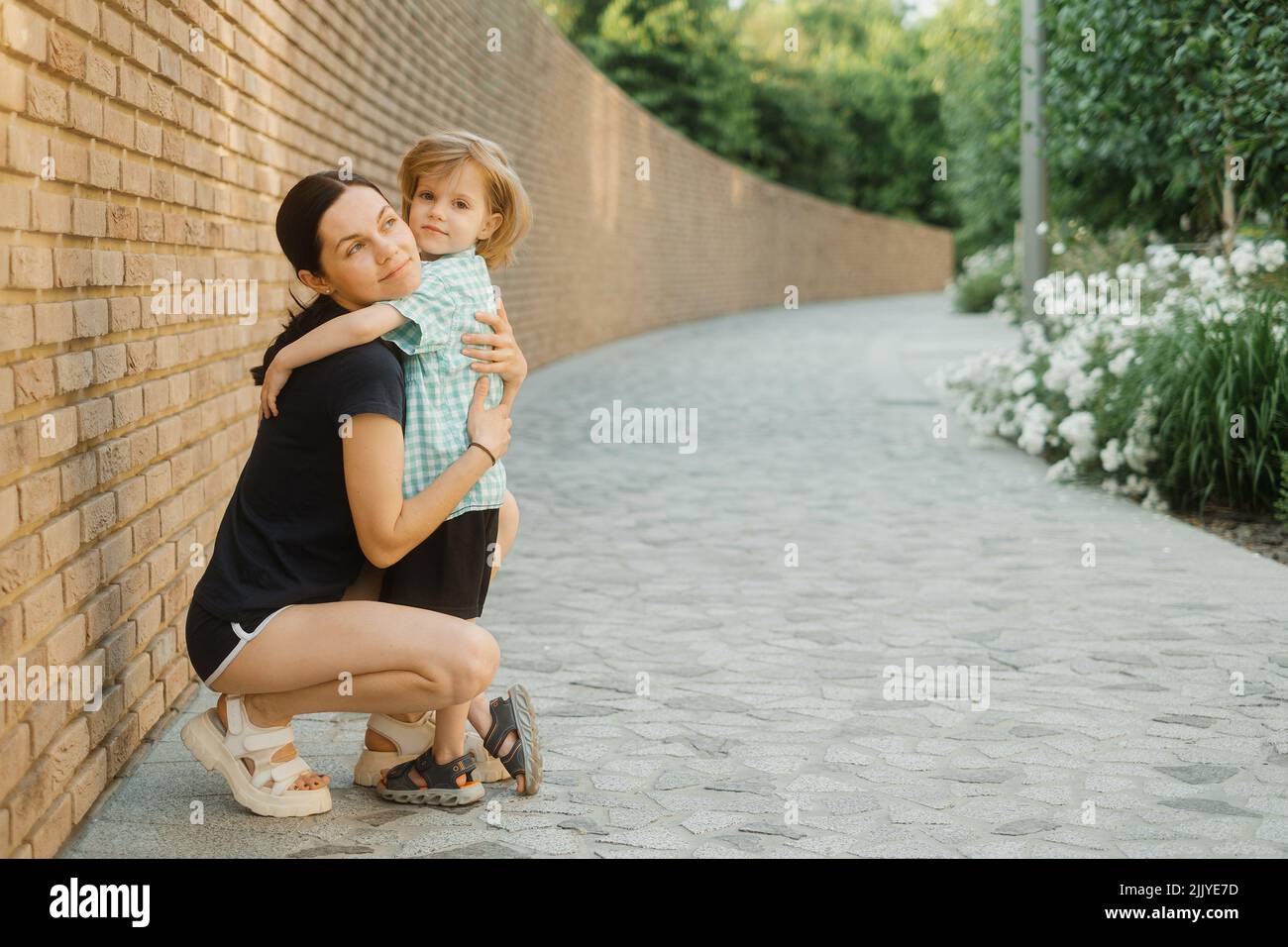 Happy beautiful mother and little son hug each other and posing in the ...