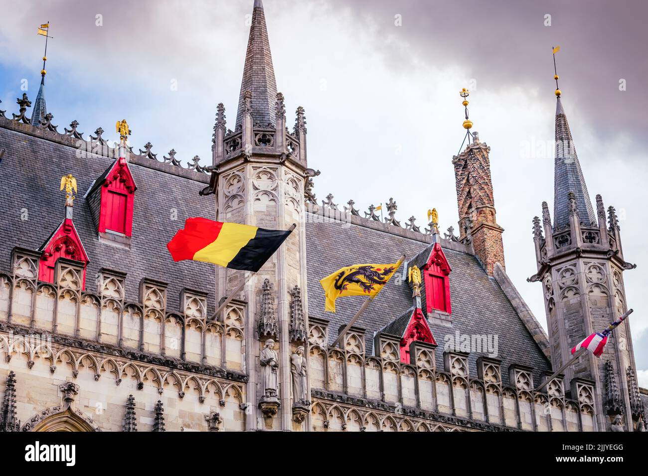 Belgian flags, flemish architecture in Bruges market square Stock Photo ...