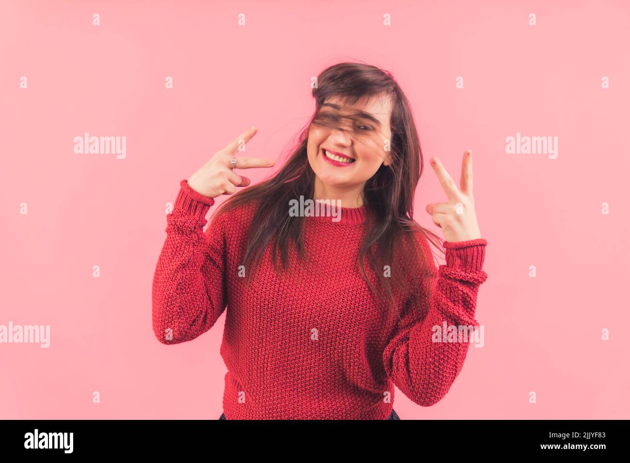 Caucasian brunette woman with flowing hair and large smile wearing red ...