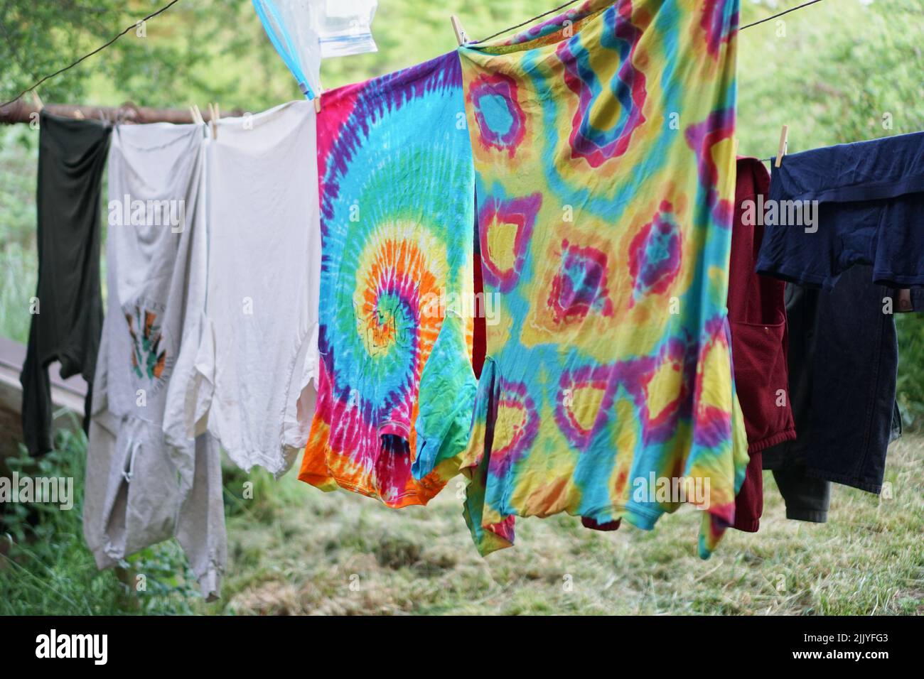 tie-died clothes hang on a clothesline to dry Stock Photo - Alamy