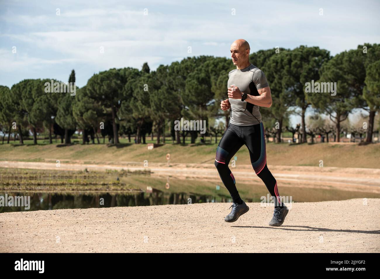 Man running in park at winter morning Stock Photo - Alamy