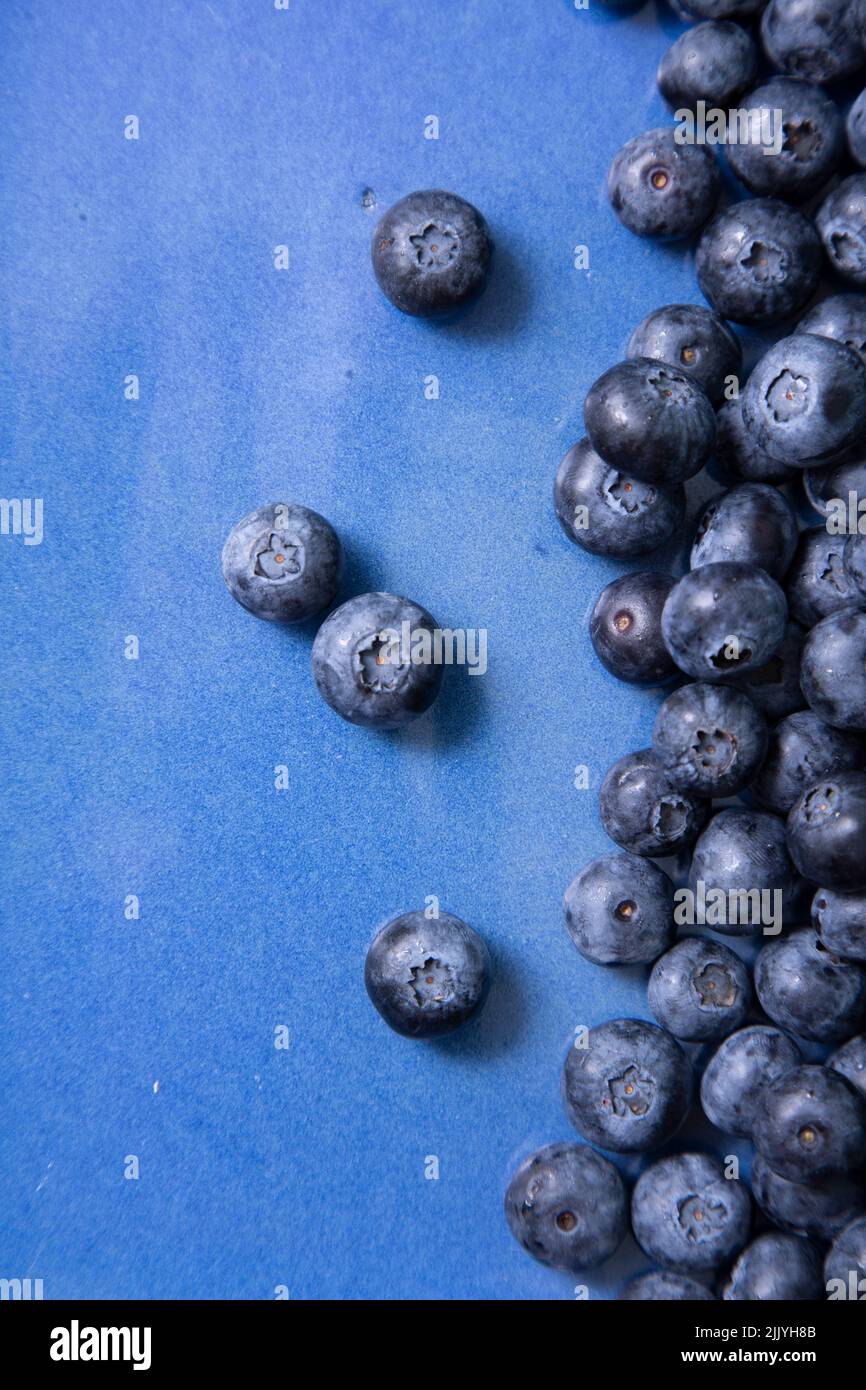 Vertical photo with scattered blueberries in a blue flat plate Stock ...