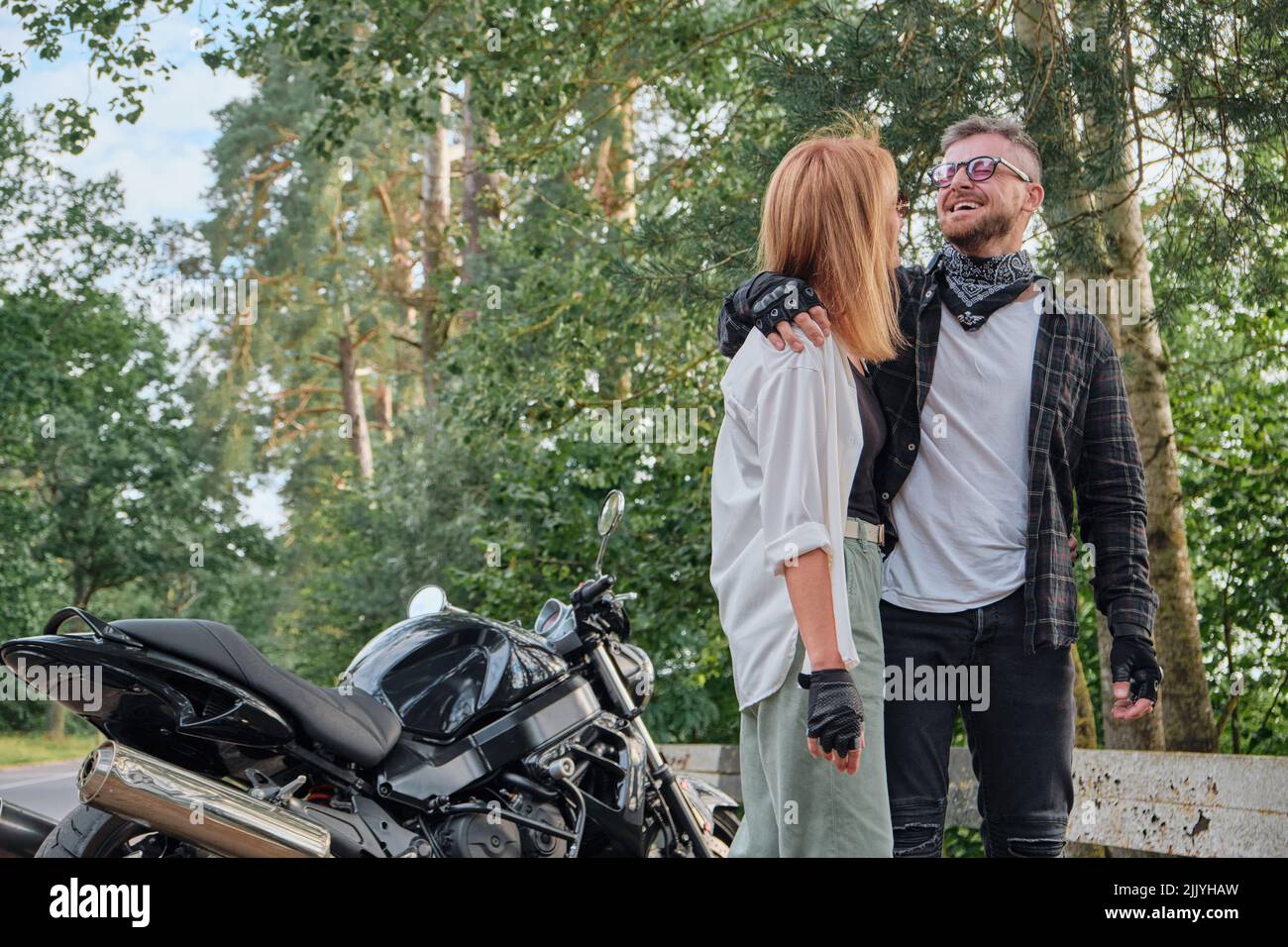 Middle age couple hugging and having fun on a motorcycle, traveling ...
