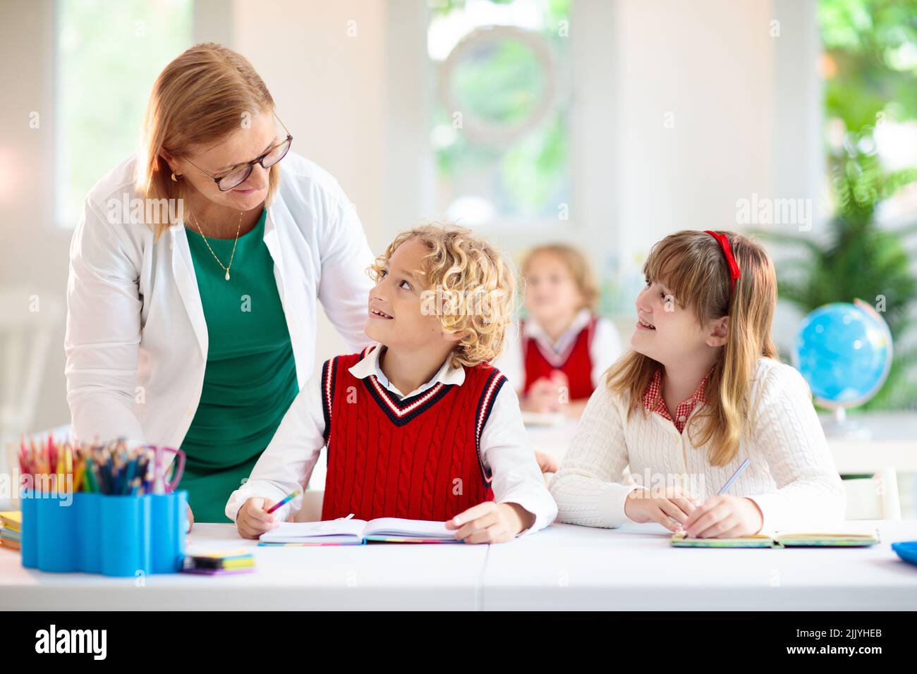 Kids in school. Preschool children in class. Happy kids back to school ...