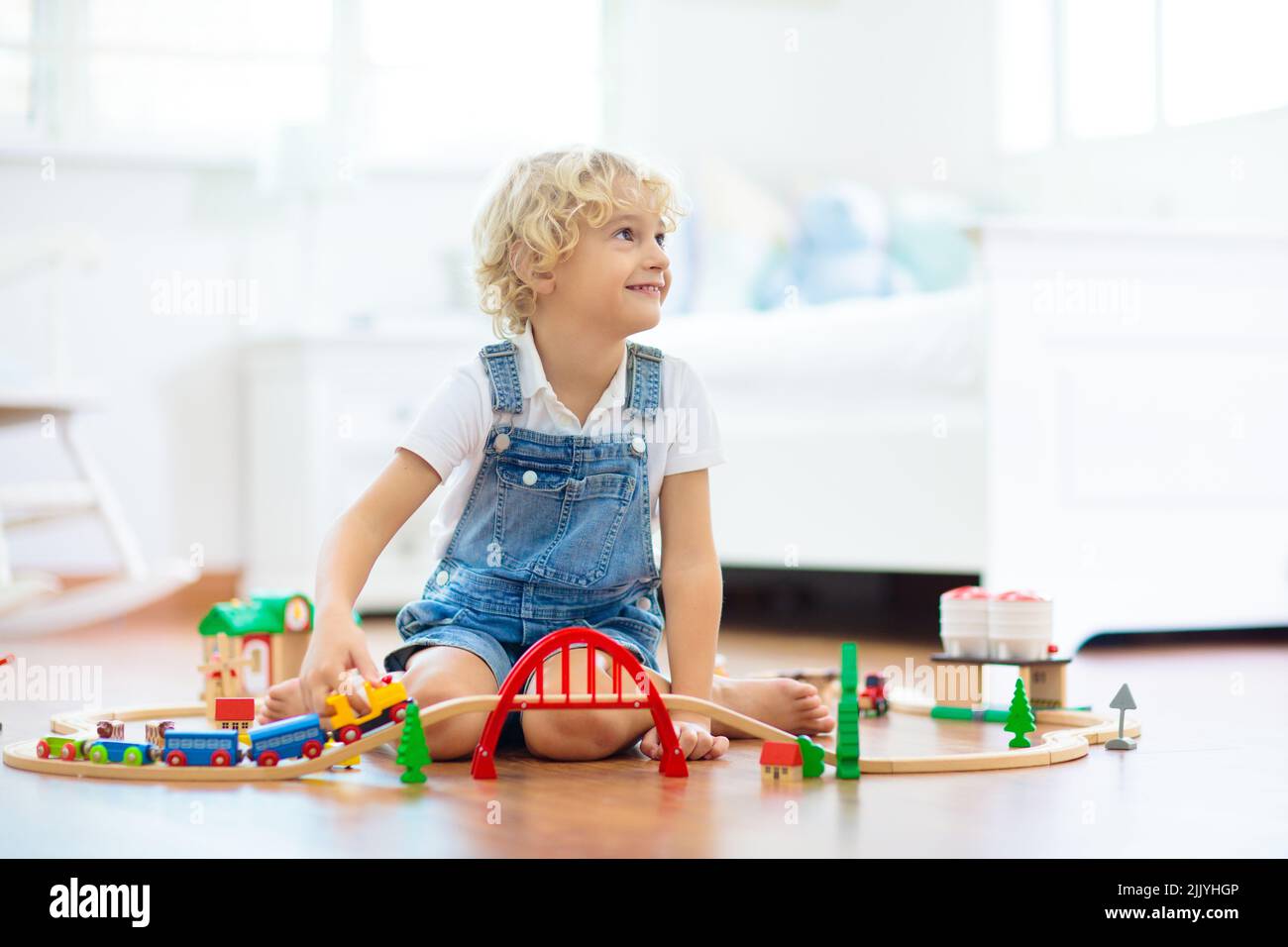 Kids play with wooden railway. Child with toy train. Educational toys ...
