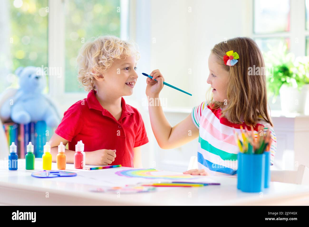 Kids paint. Child painting in white sunny study room. Little boy and ...