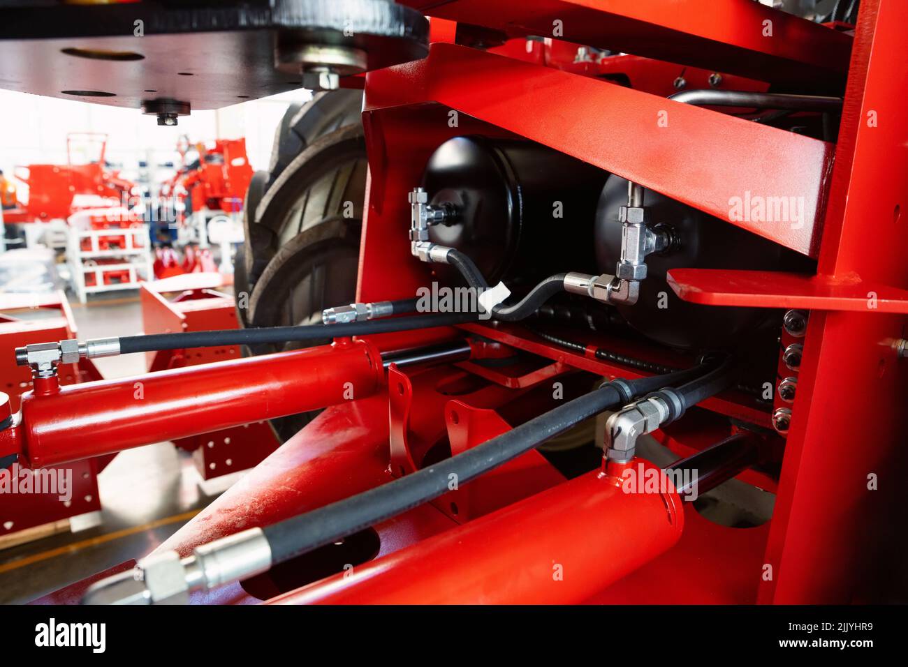 Close-up image of parts of new tractor at agricultural machinery plant ...