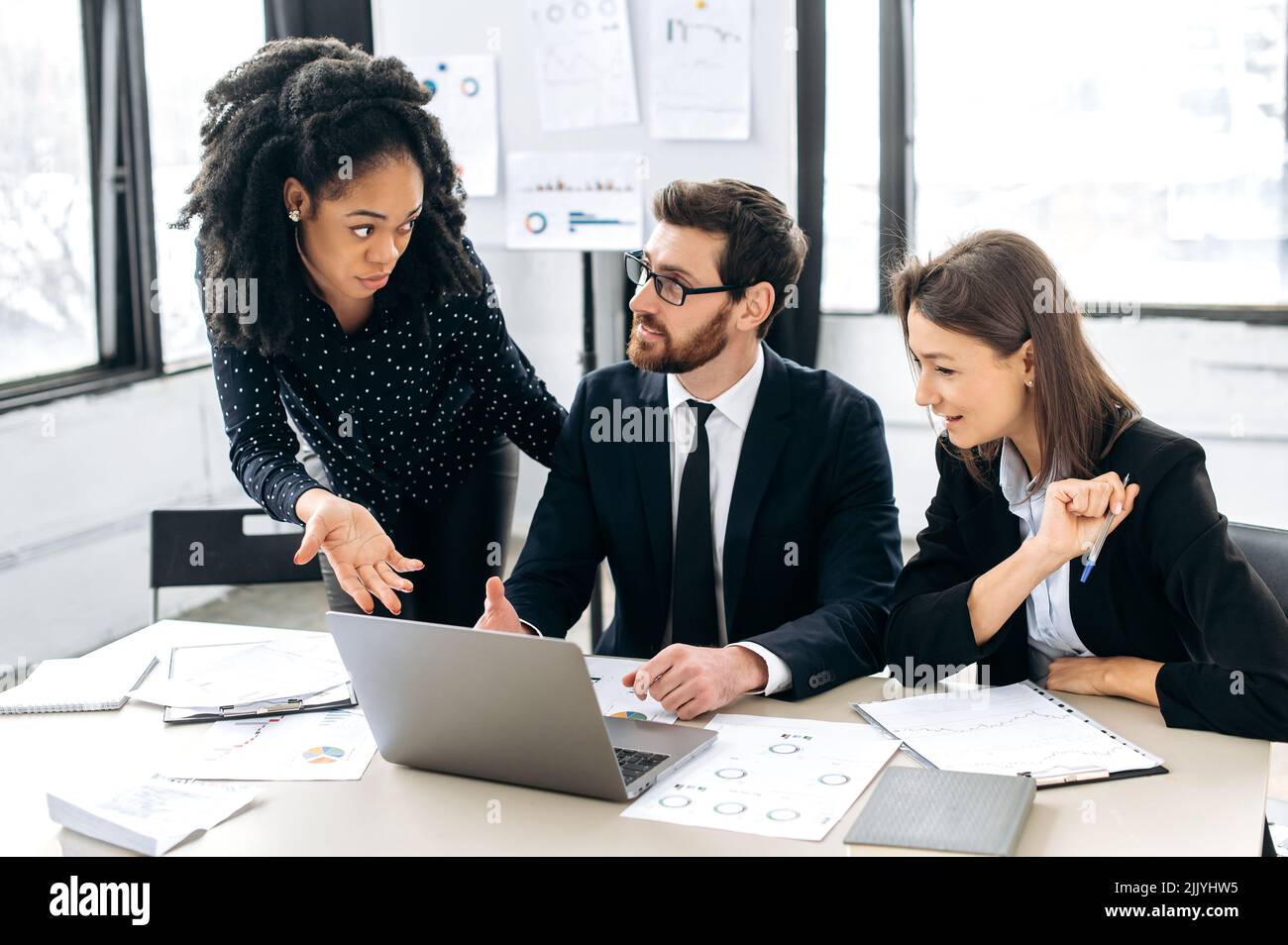 Business partners working together on a project. Multiracial colleagues are brainstorming on ...