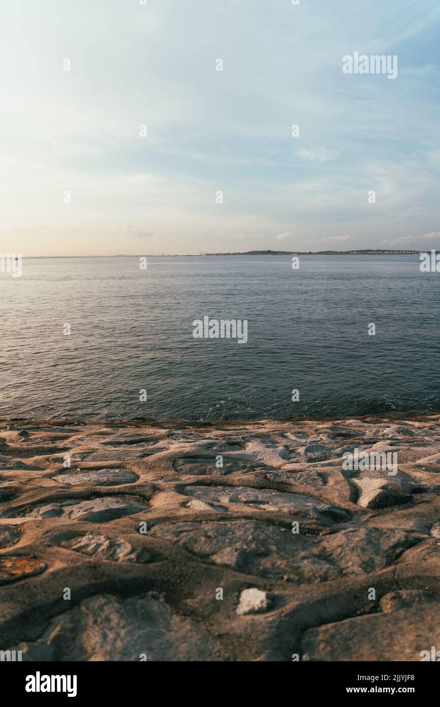 A vertical shot of a sandy beach with a waterscape and horizon Stock ...