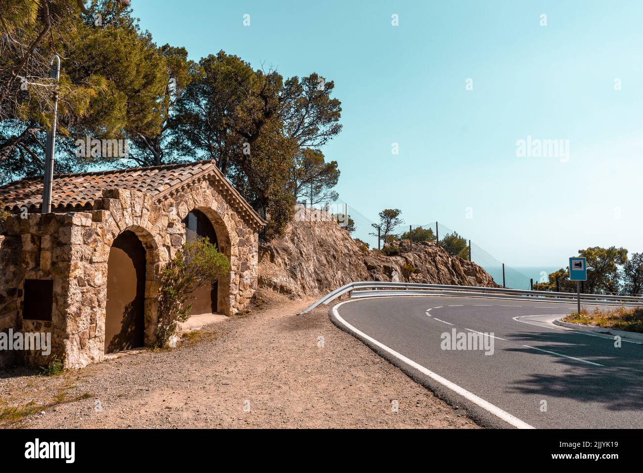 Sharp street turn on the coastal road. Viewpoint with stone wall ...