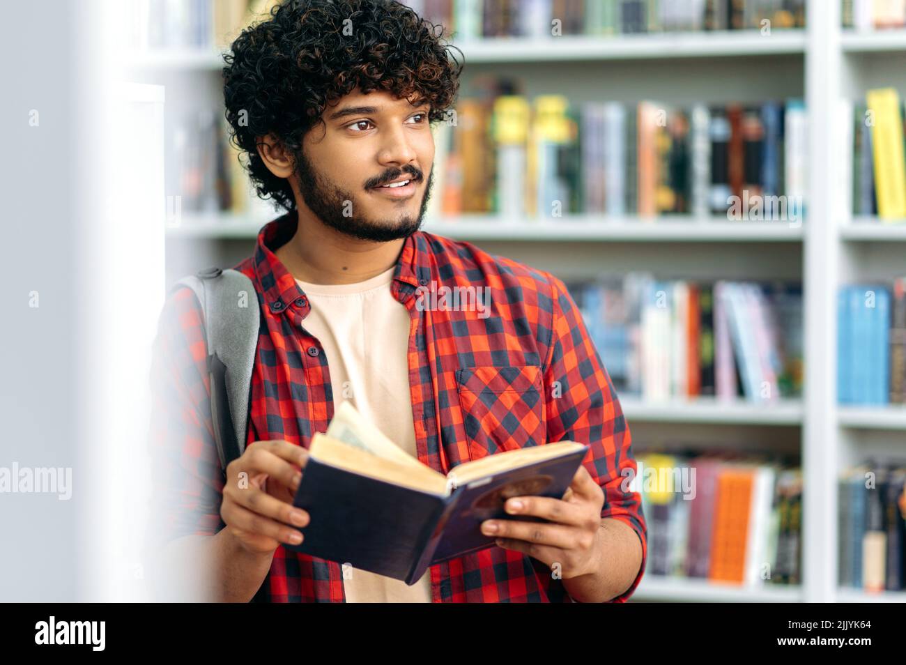 Clever concentrated indian guy doing hi-res stock photography and ...