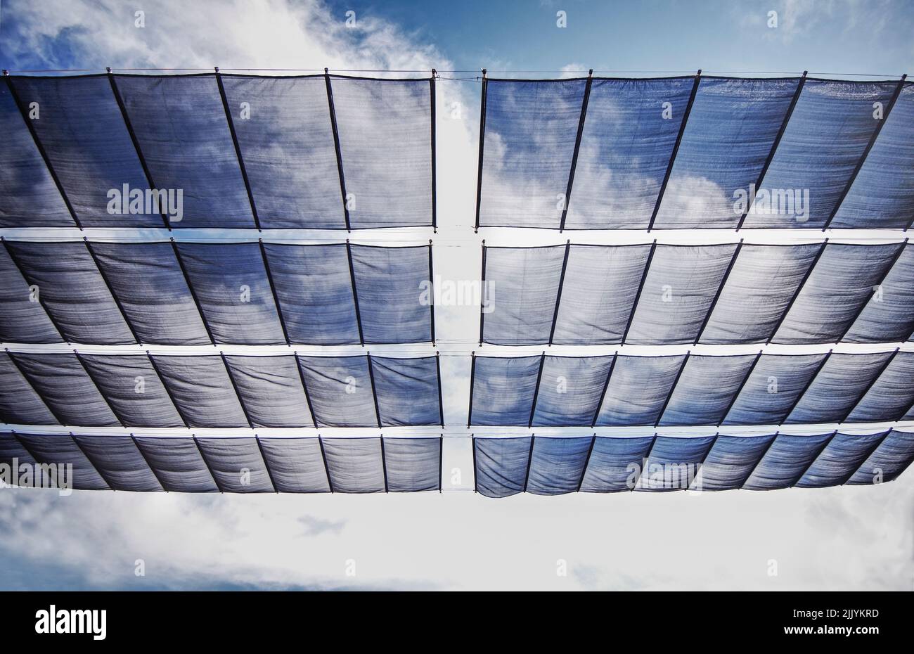 Overhead shadecloth against blues and cloudy sky Stock Photo - Alamy