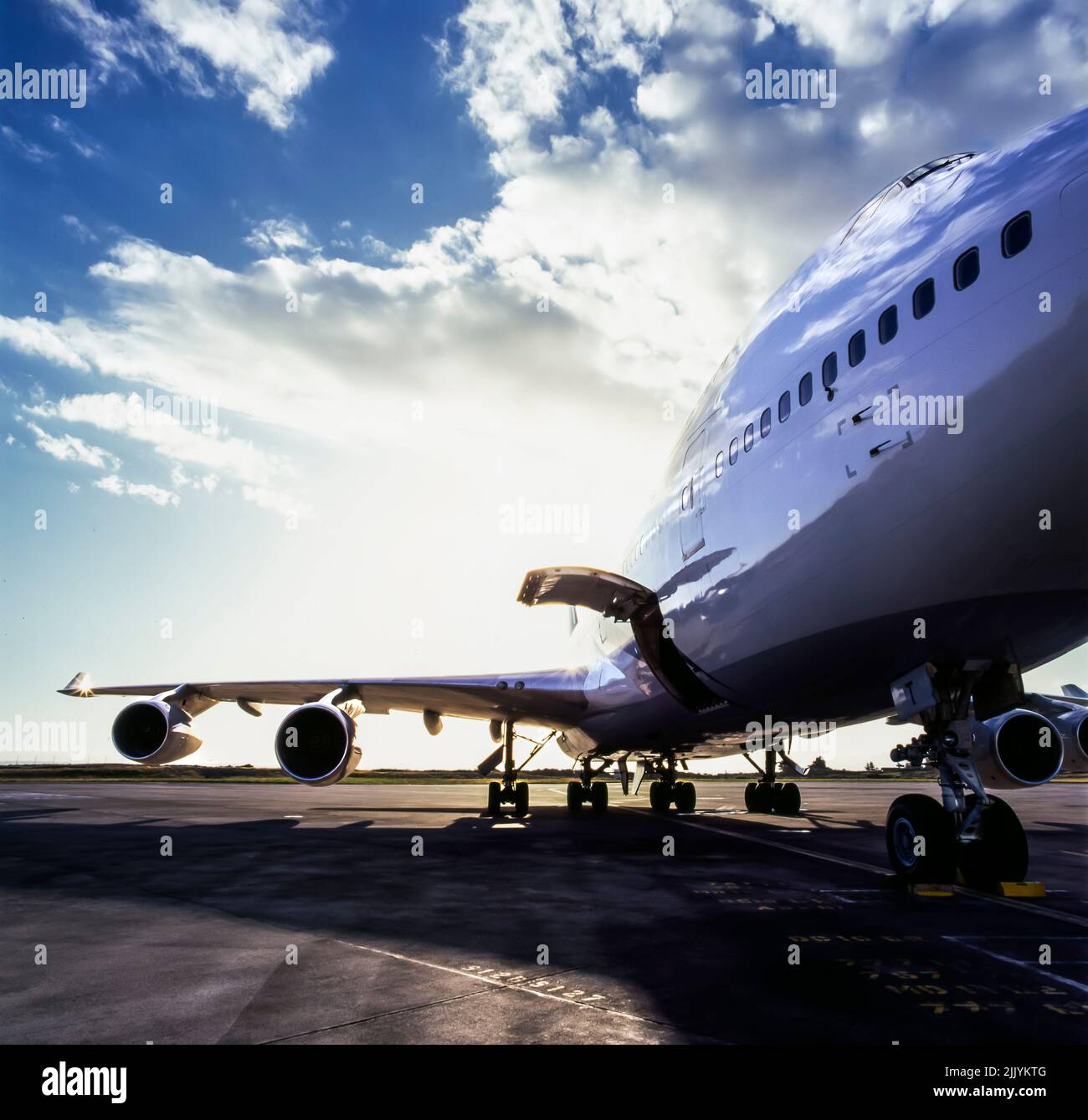 Close up of aeroplane parked on runway with hatch door open Stock Photo ...
