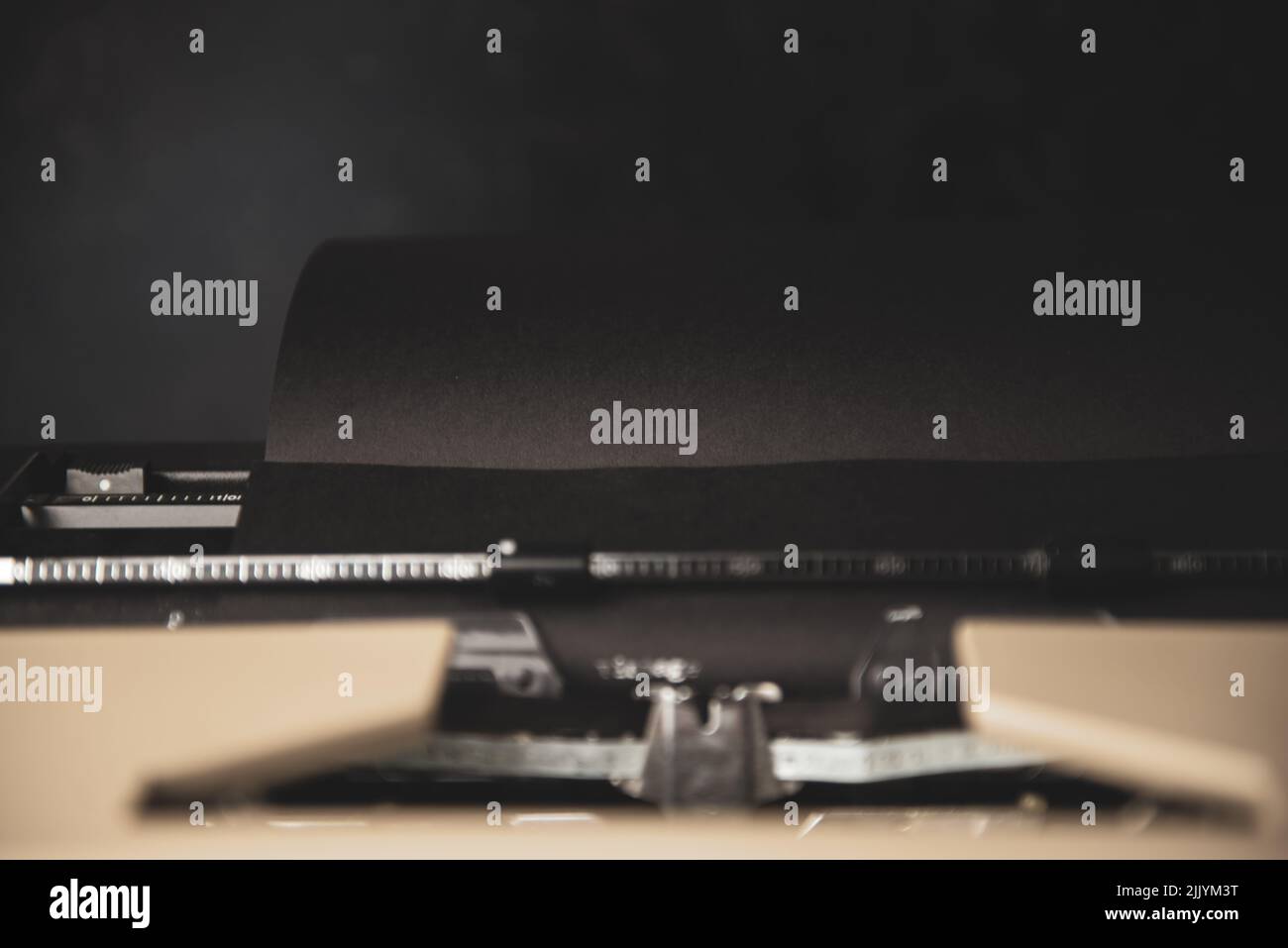 Vintage typewriter with black paper and white ink showing the word ...