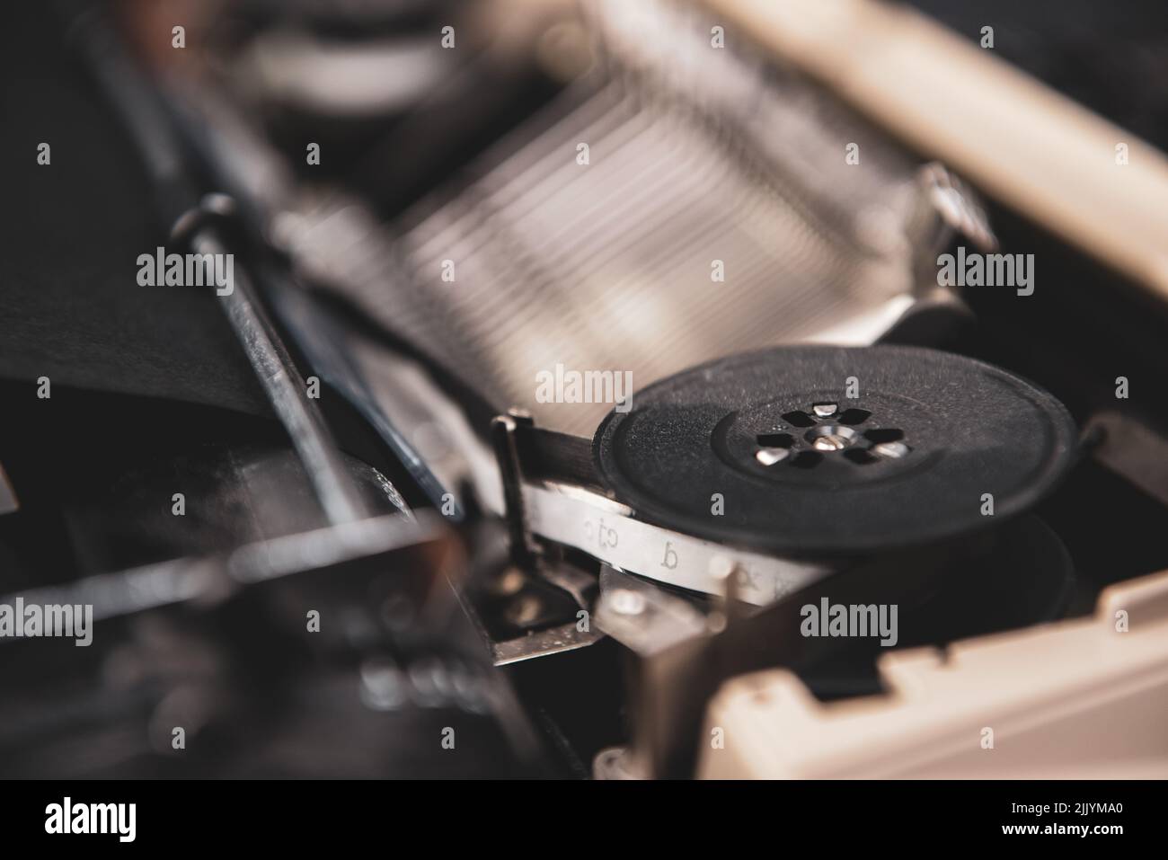 Focus on ink ribbon on old vintage typewriter with black and white ink ...