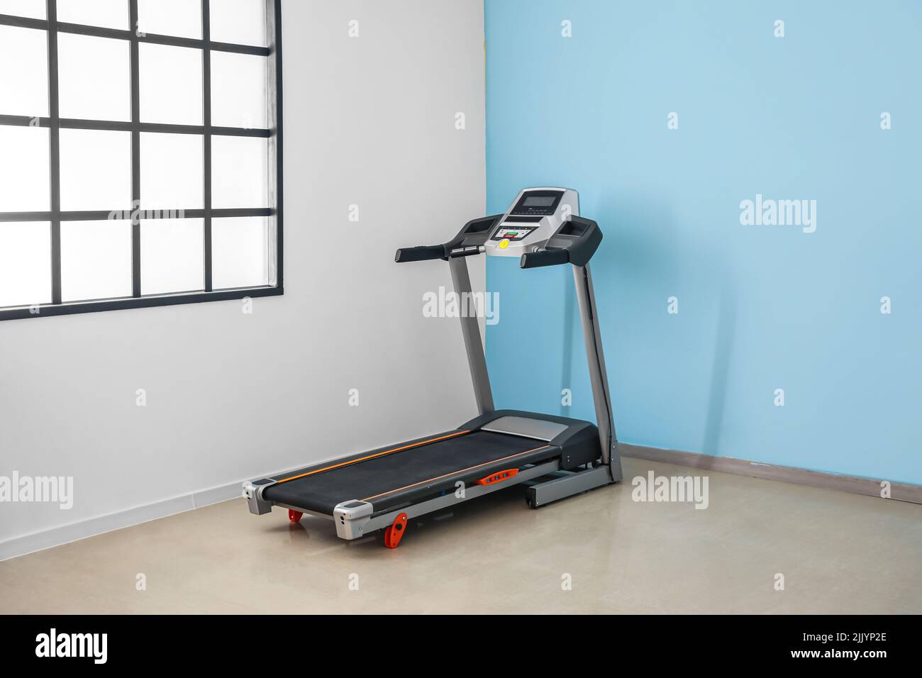 Modern treadmill in stylish room Stock Photo - Alamy