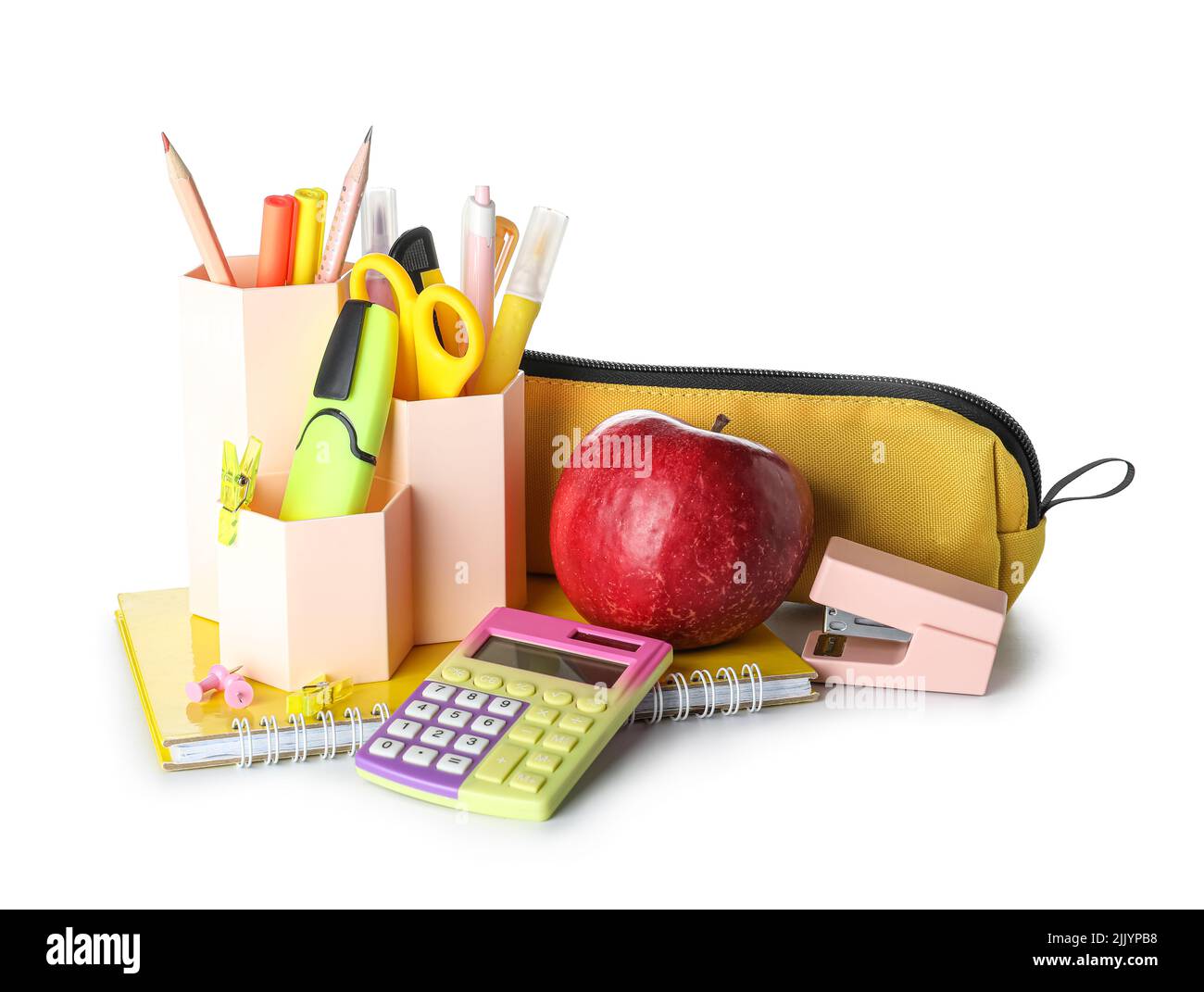 Cups with school stationery, pencil case and apple on white background ...