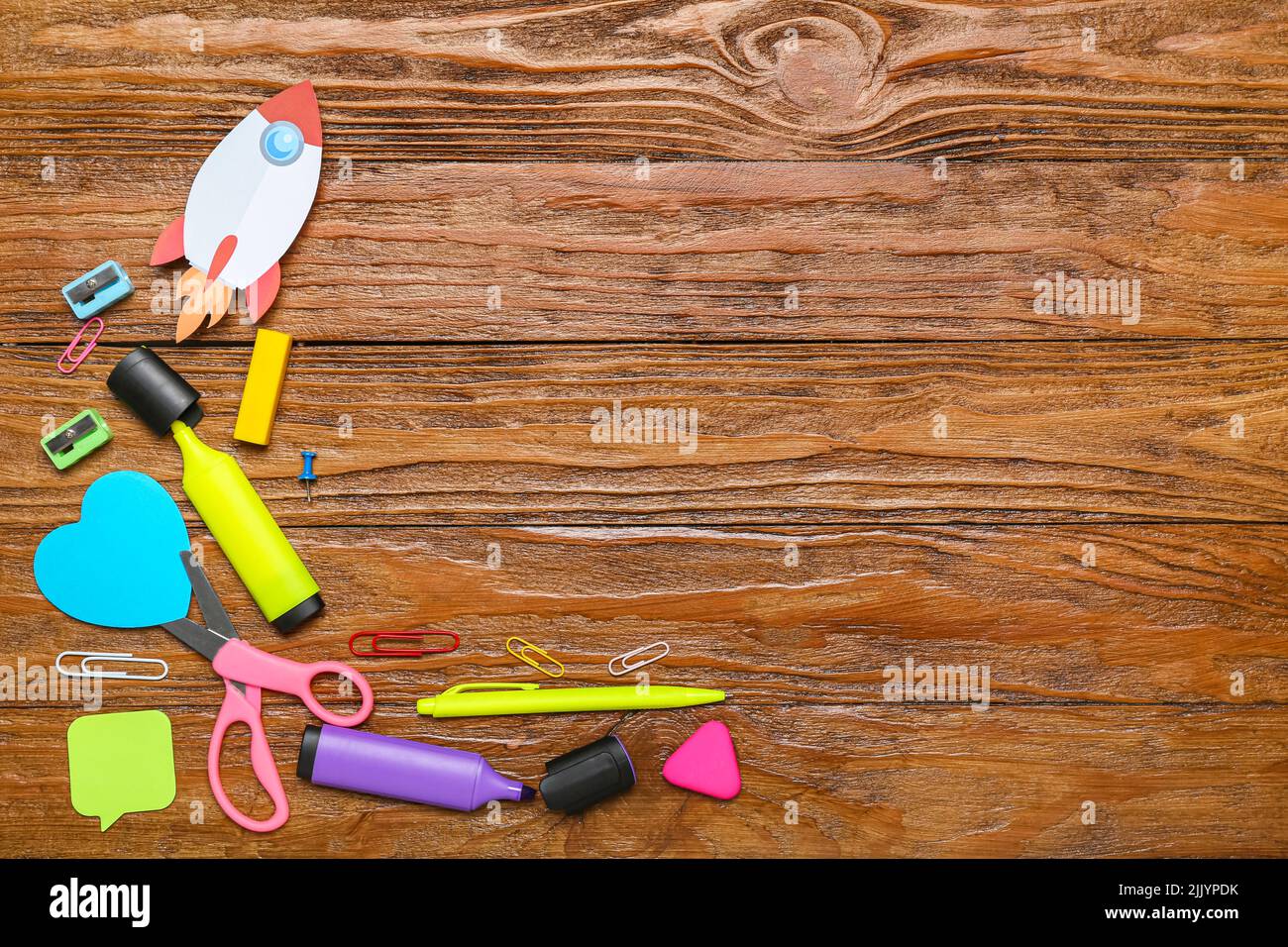 Paper rocket with school stationery on wooden background Stock Photo ...