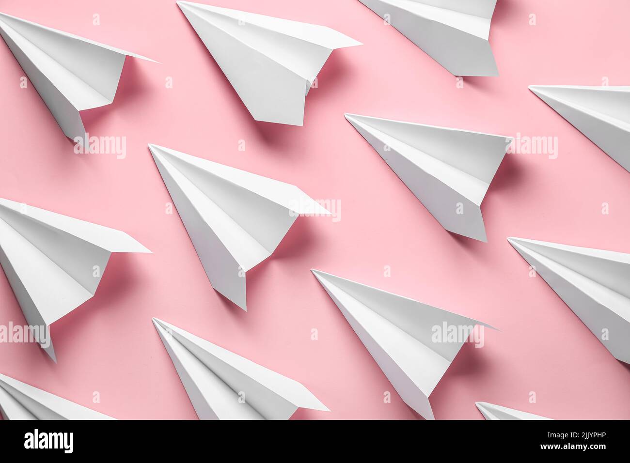 Paper planes on pink background Stock Photo - Alamy