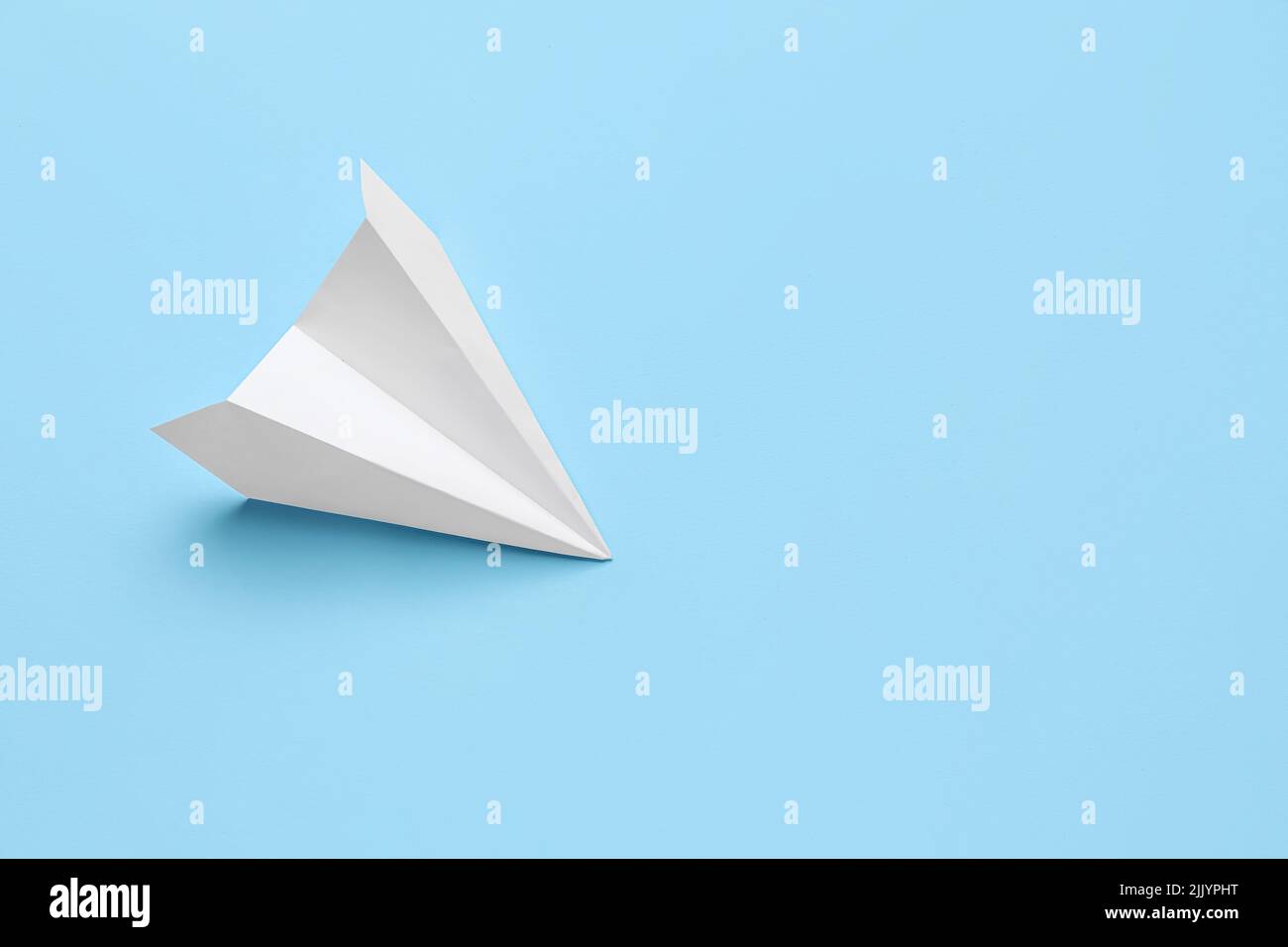 Paper plane on blue background Stock Photo - Alamy