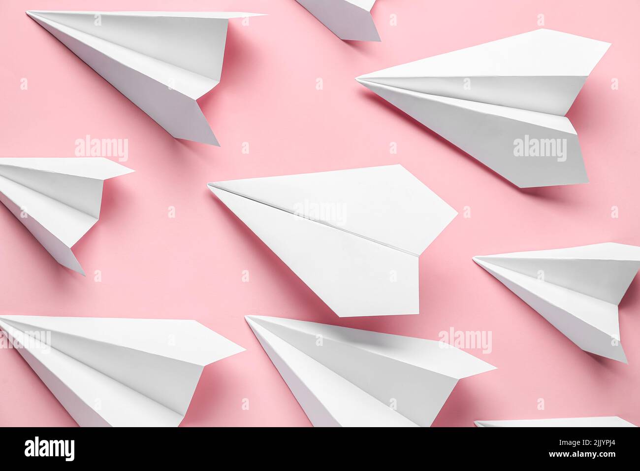 Paper planes on pink background Stock Photo - Alamy