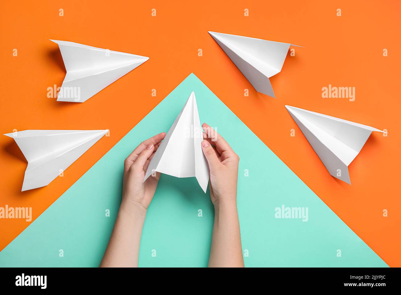 Woman with paper planes on color background Stock Photo - Alamy
