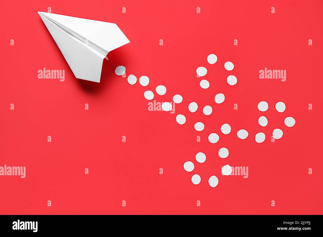 Paper plane and dots on red background Stock Photo - Alamy