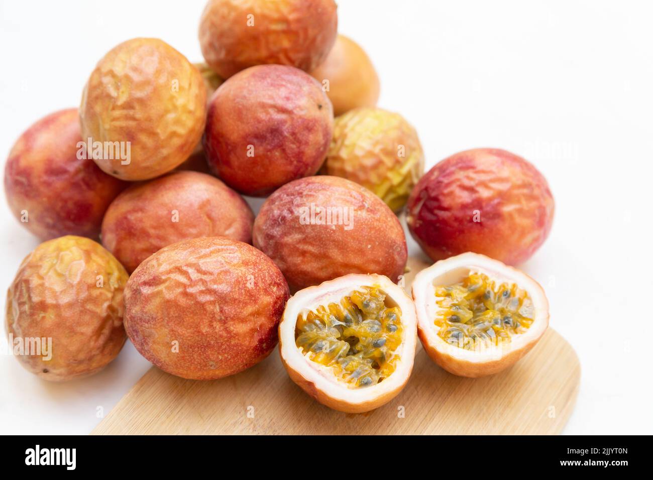 Delicious whole passion fruit shown here with one sliced in half ...